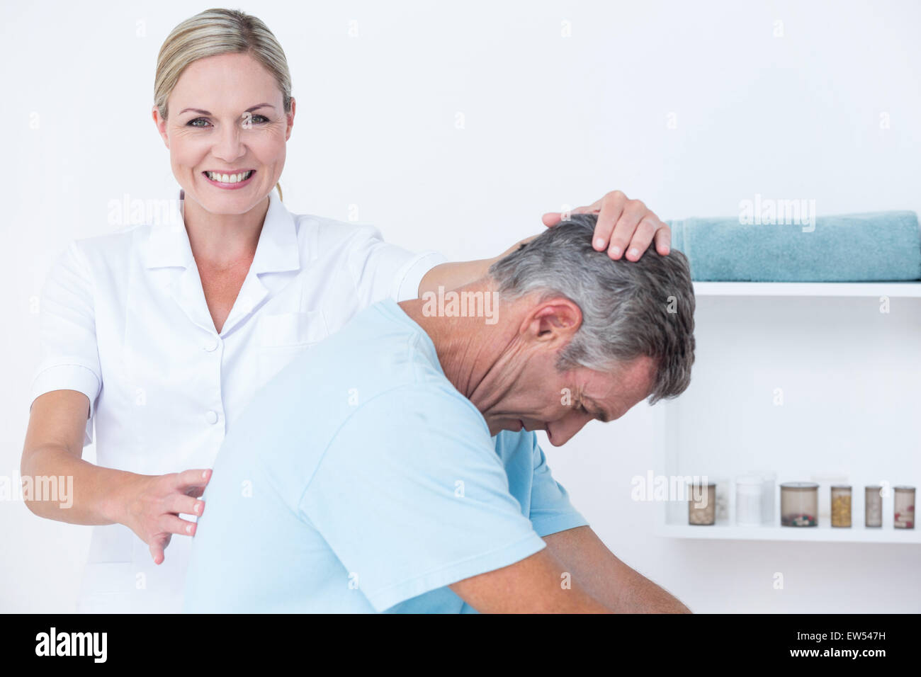 Doctor stretching a man back Stock Photo - Alamy