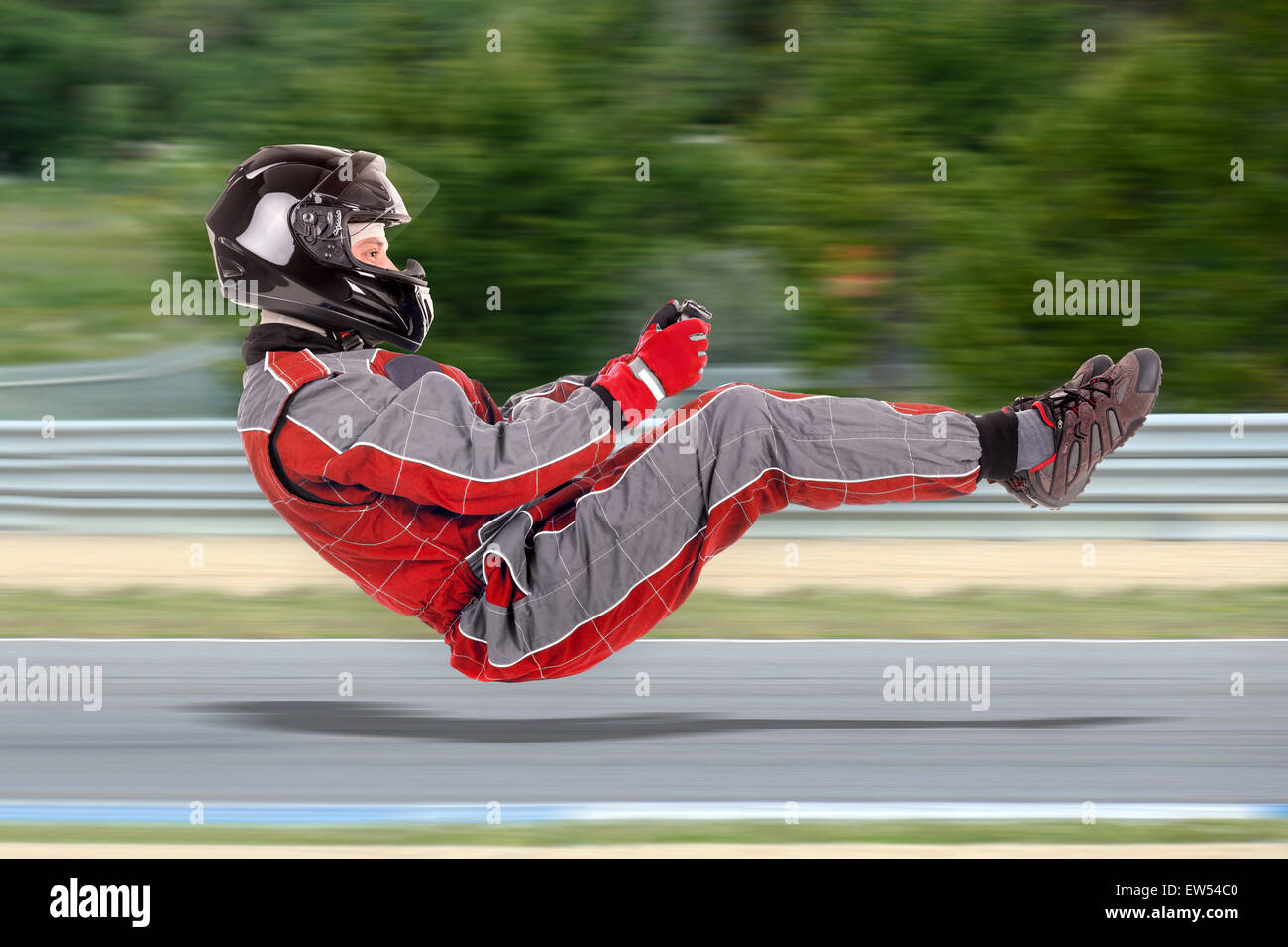 Racing driver on track in driving position in full gear Stock Photo - Alamy