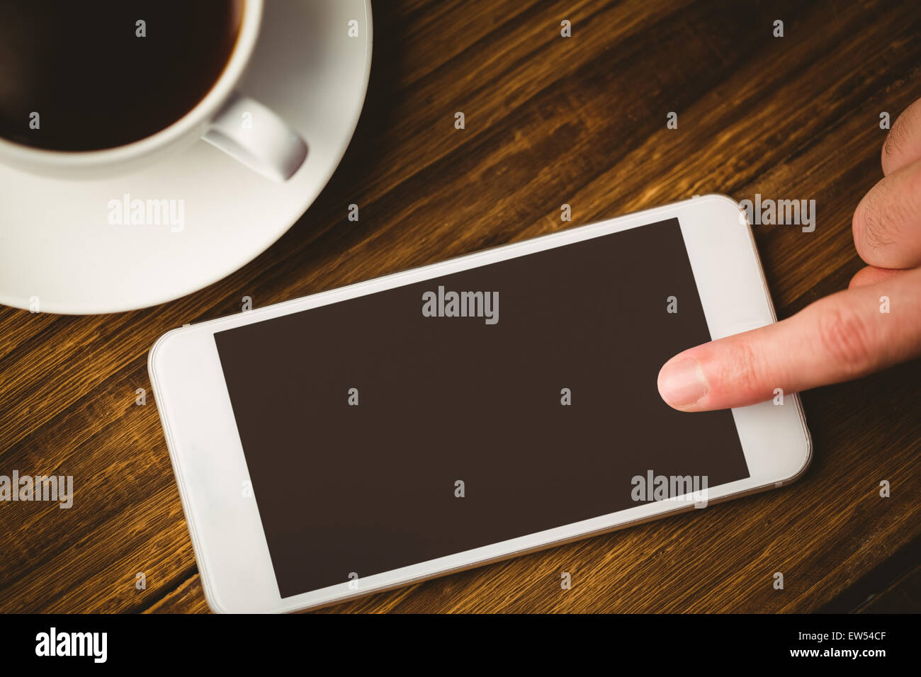 Hand pointing the smartphone Stock Photo - Alamy