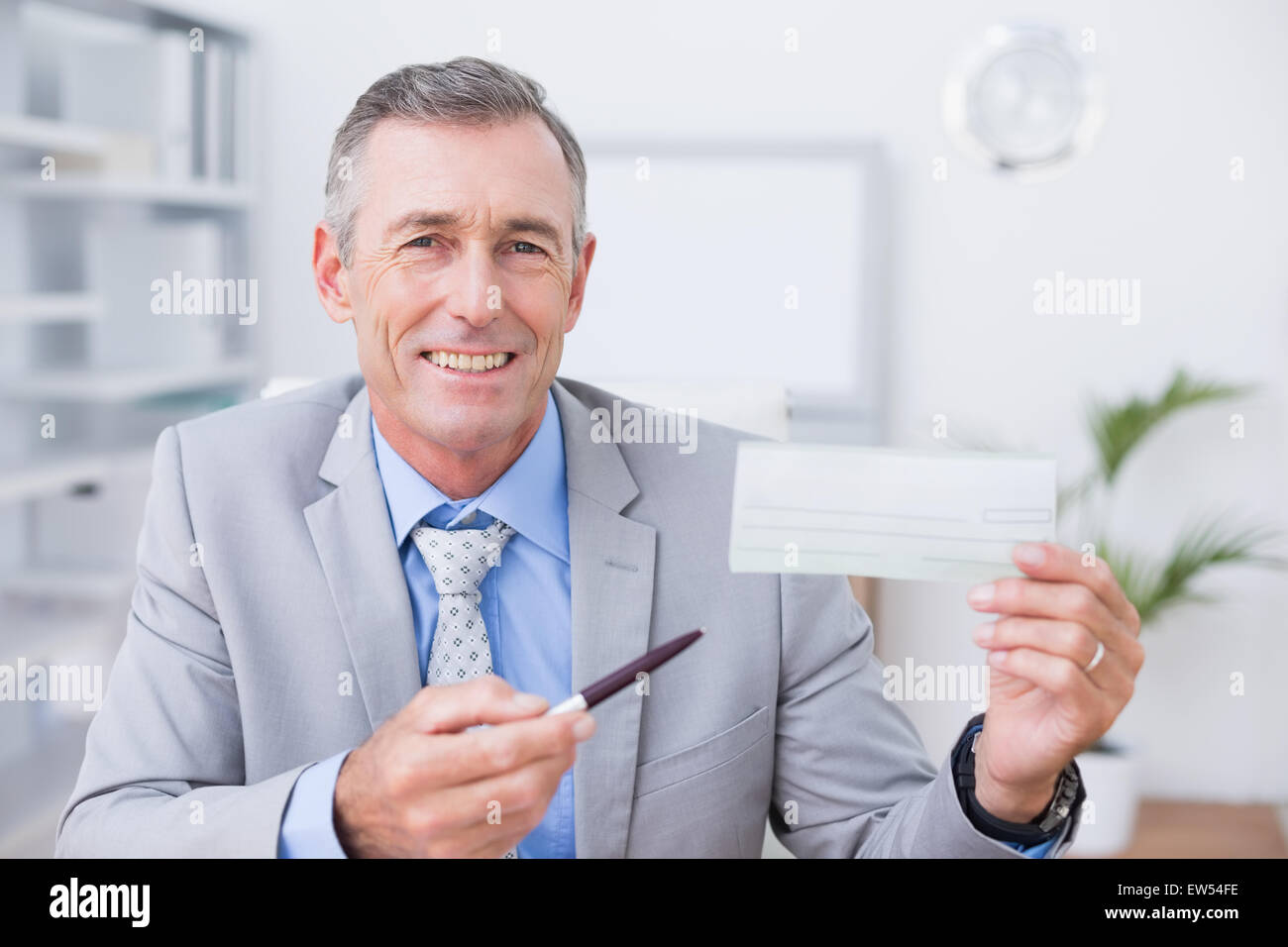 Man holding cheque hi-res stock photography and images - Alamy