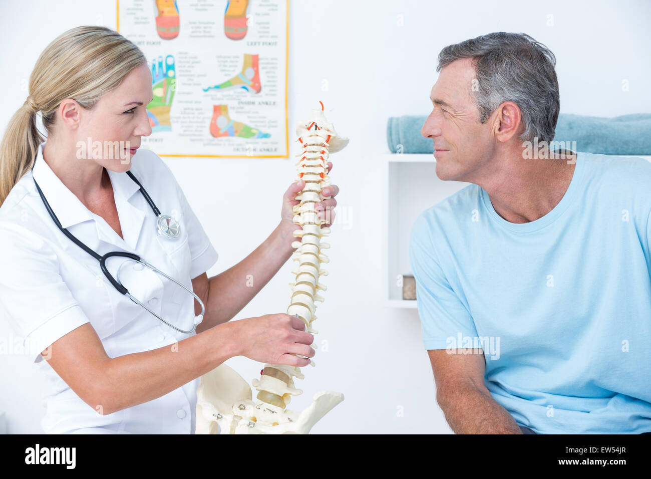 Doctor showing patient spine model hi-res stock photography and images ...