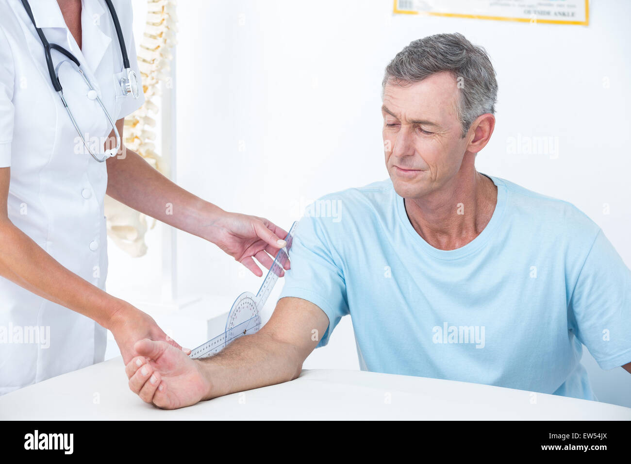 Doctor measuring arm with goniometer Stock Photo - Alamy