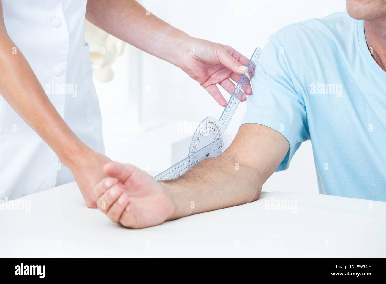 Doctor measuring arm with goniometer Stock Photo - Alamy