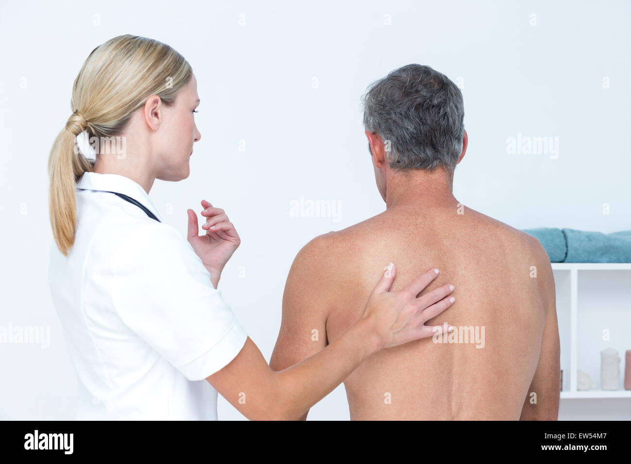 Doctor examining patient back hi-res stock photography and images - Alamy