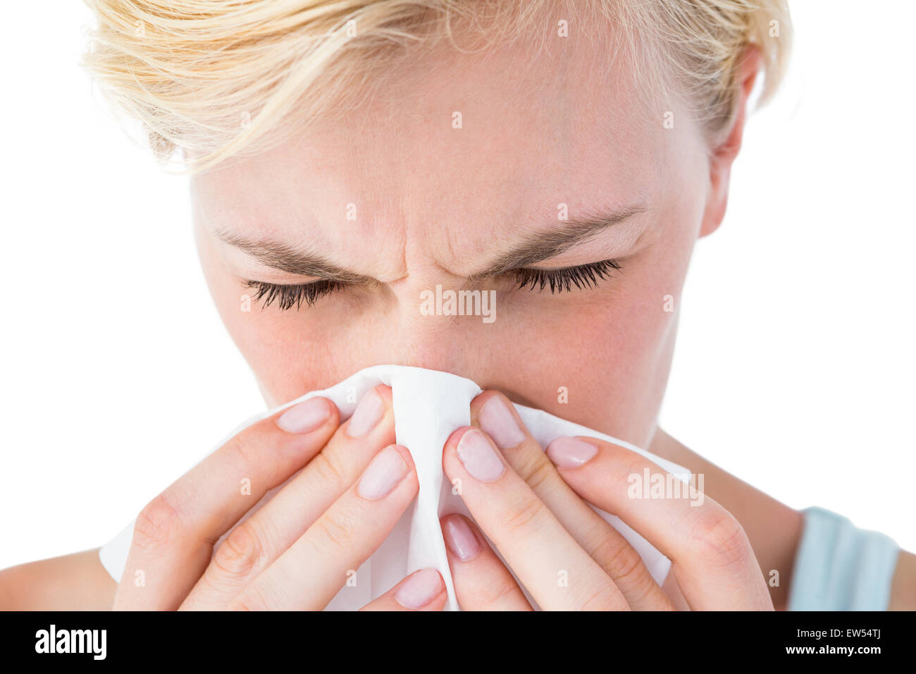 Attractive woman blowing her nose Stock Photo - Alamy