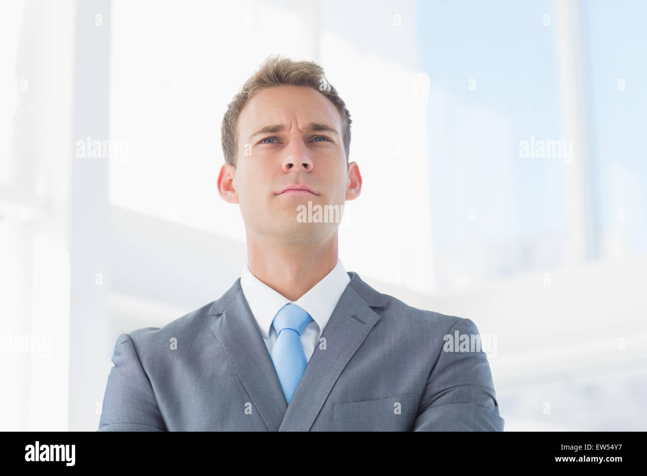 Serious businessman looking away Stock Photo - Alamy
