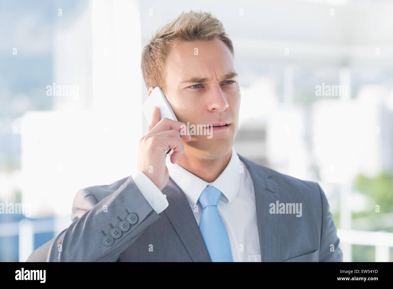 Thoughtful businessman calling on the phone Stock Photo - Alamy