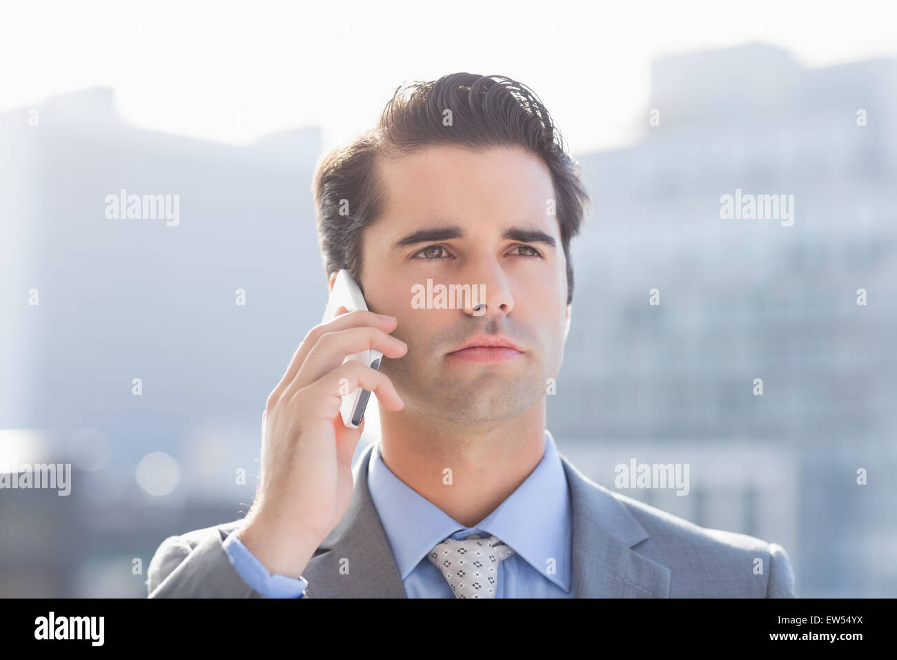 Thoughtful businessman calling on the phone Stock Photo - Alamy