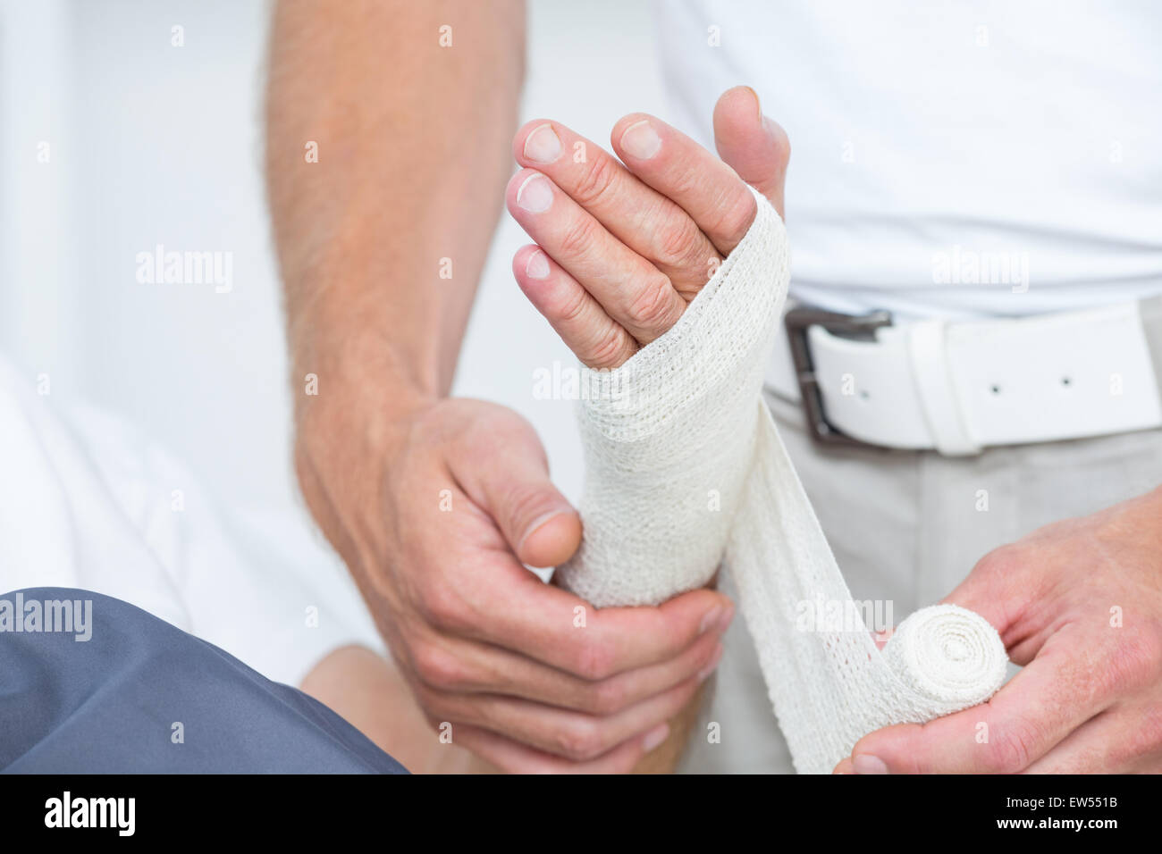 Doctor bandaging his patient hand Stock Photo - Alamy