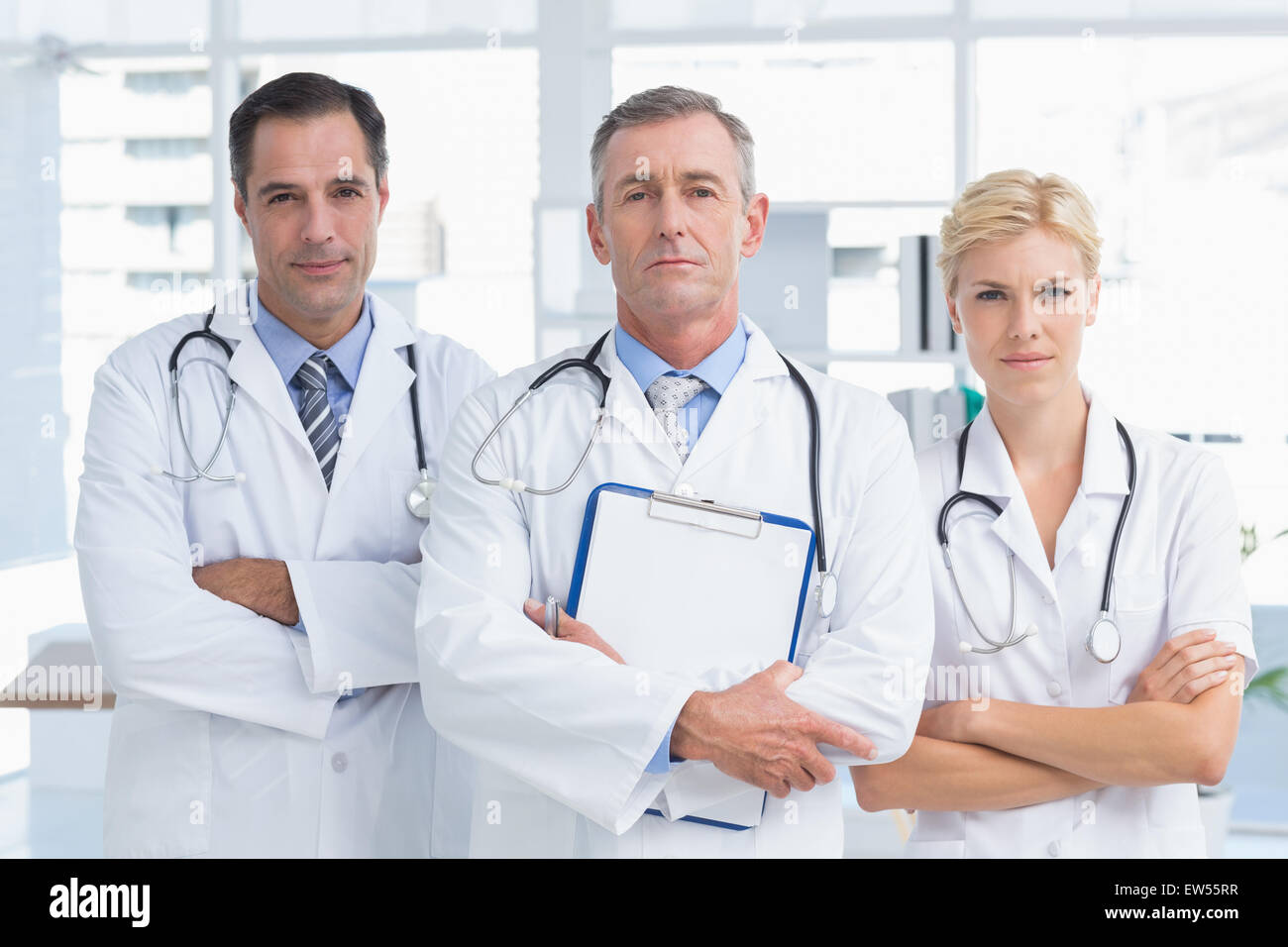 Concentrated doctors looking at camera Stock Photo - Alamy