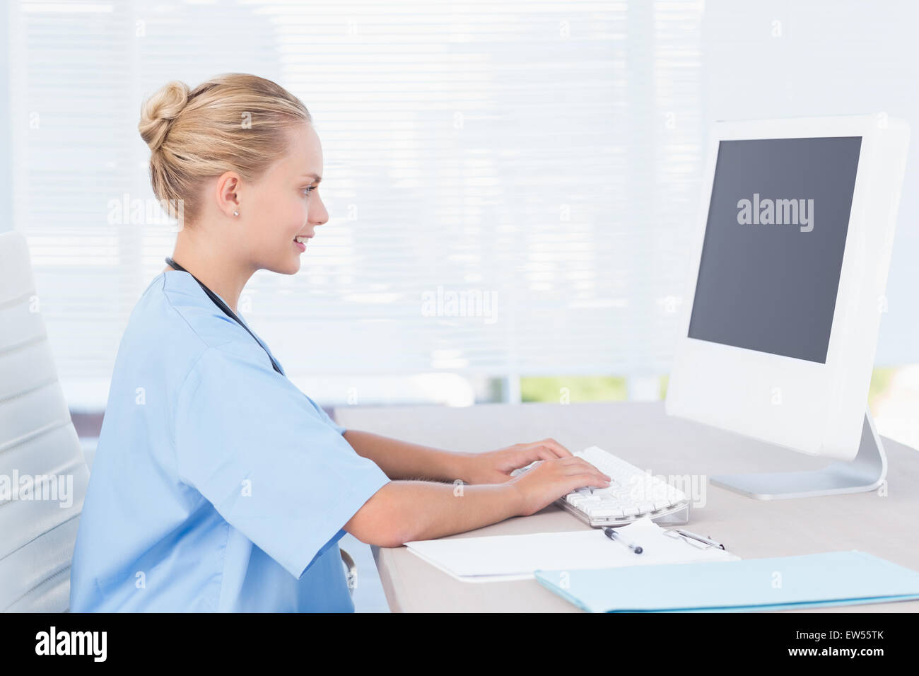 Smiling nurse using computer Stock Photo - Alamy