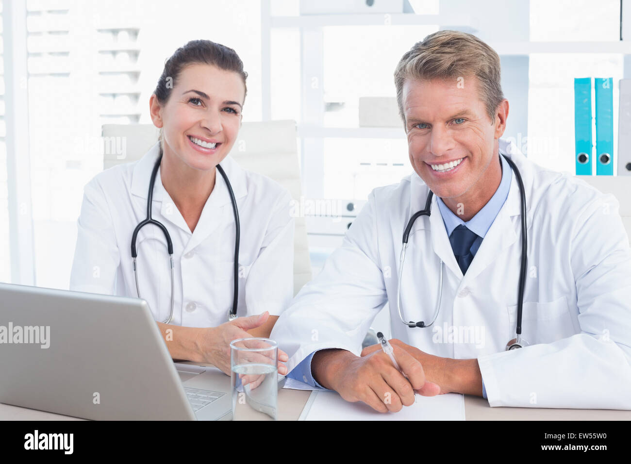 Smiling doctors looking at camera Stock Photo - Alamy