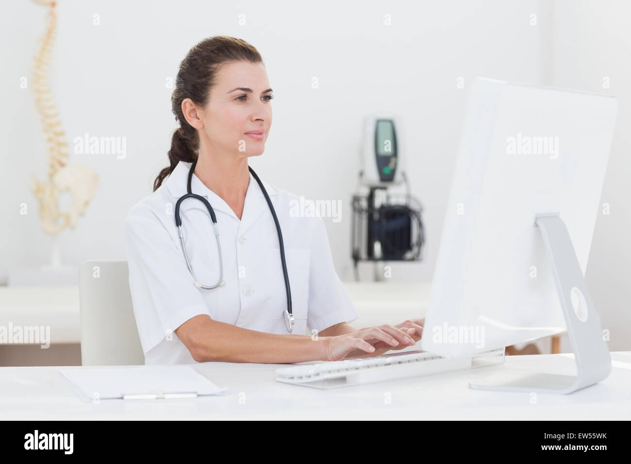 Concentrated female doctor using computer Stock Photo - Alamy