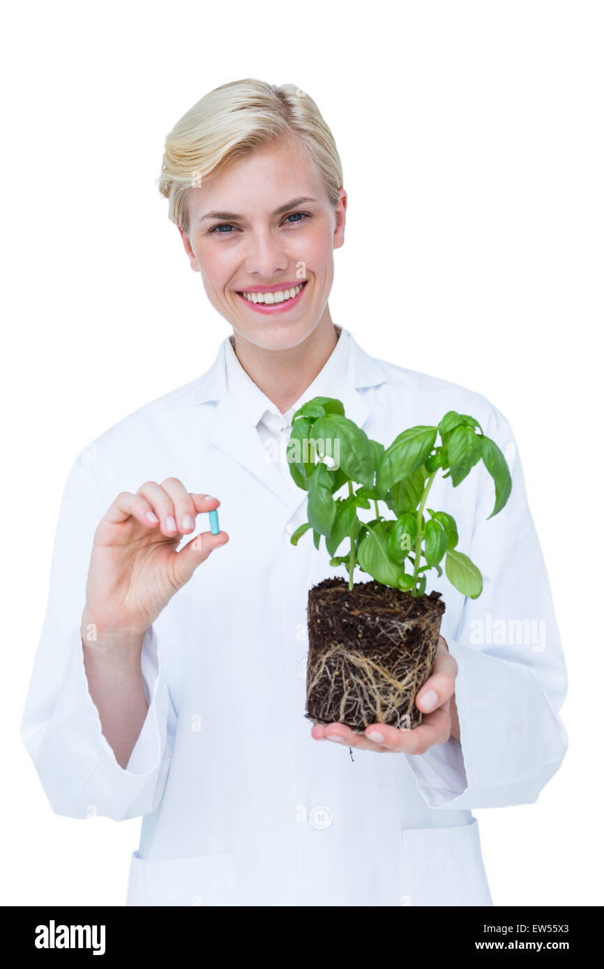 Smiling doctor holing basil plant and blue pill Stock Photo - Alamy
