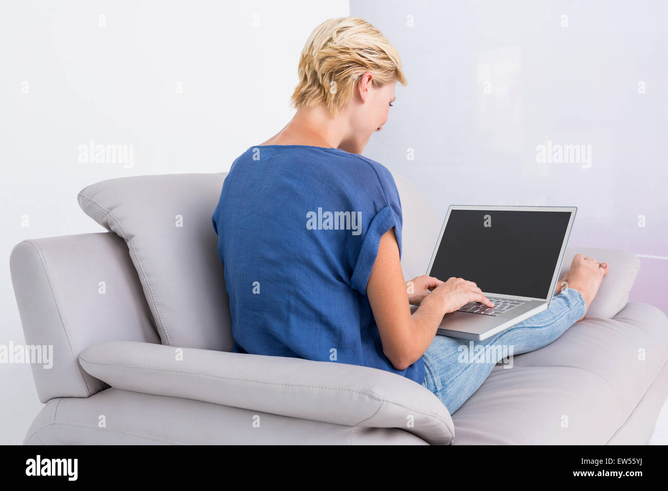 Laptop on couch with white background hi-res stock photography and ...