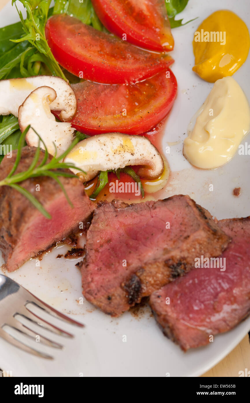 beef filet mignon grilled with fresh vegetables on side ,mushrooms tomato and arugula salad ...