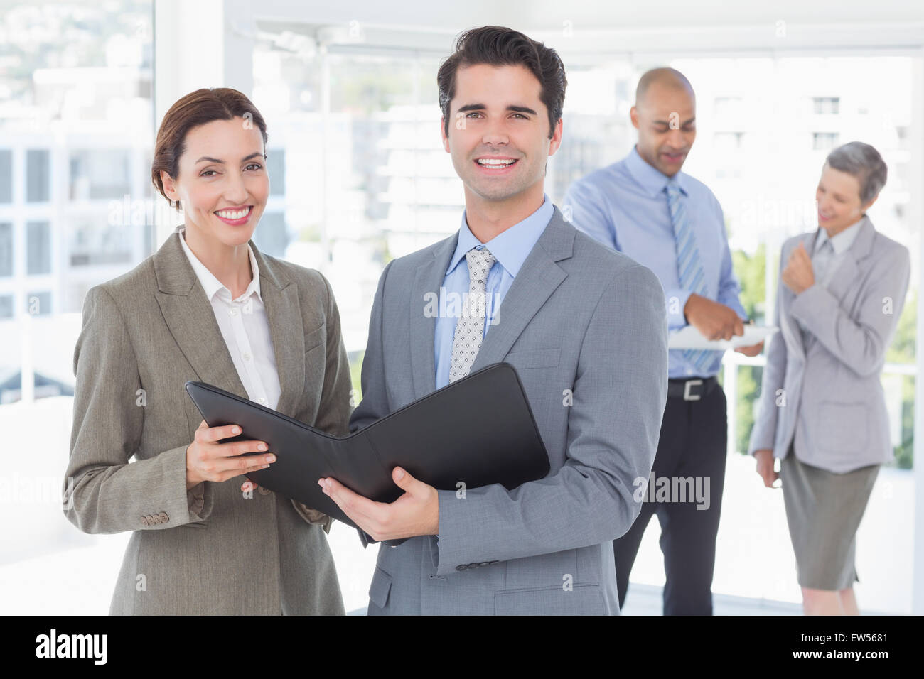 Colleagues speaking about work Stock Photo - Alamy