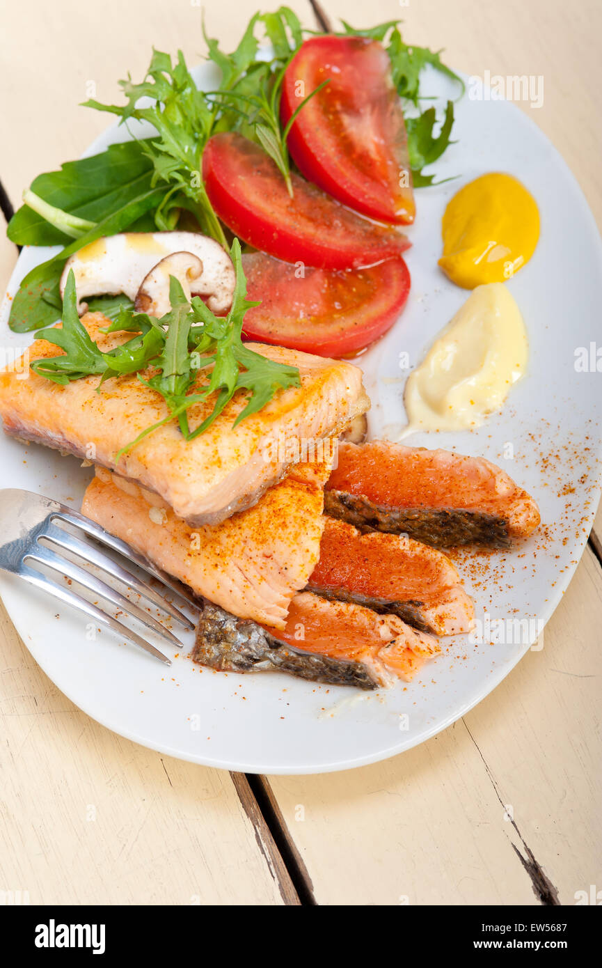 grilled fresh samon filet with vegetables salad tomato arugula ...