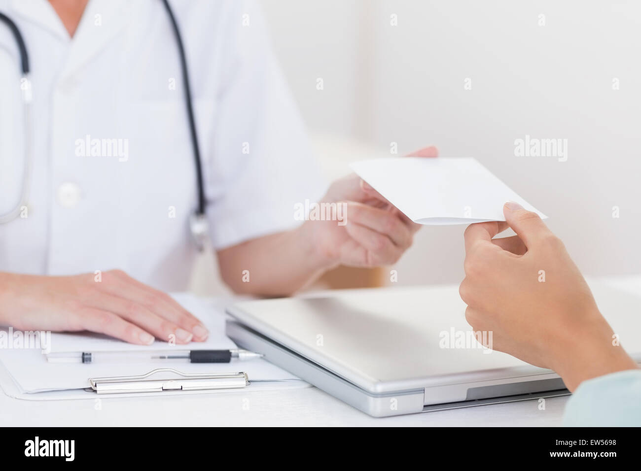 Doctor giving prescription to her patient Stock Photo - Alamy