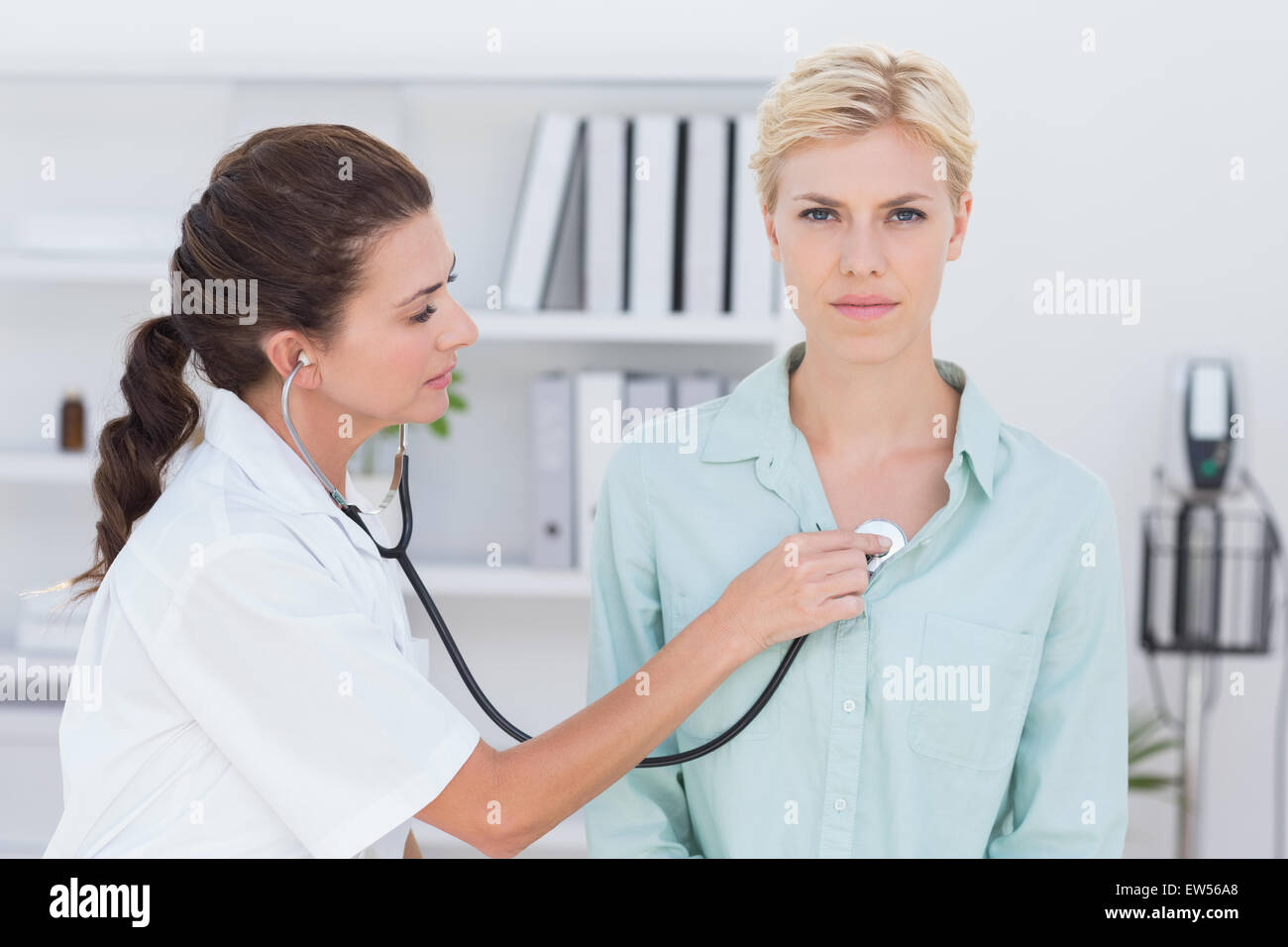 Doctor listening to patients chest with stethoscope Stock Photo - Alamy