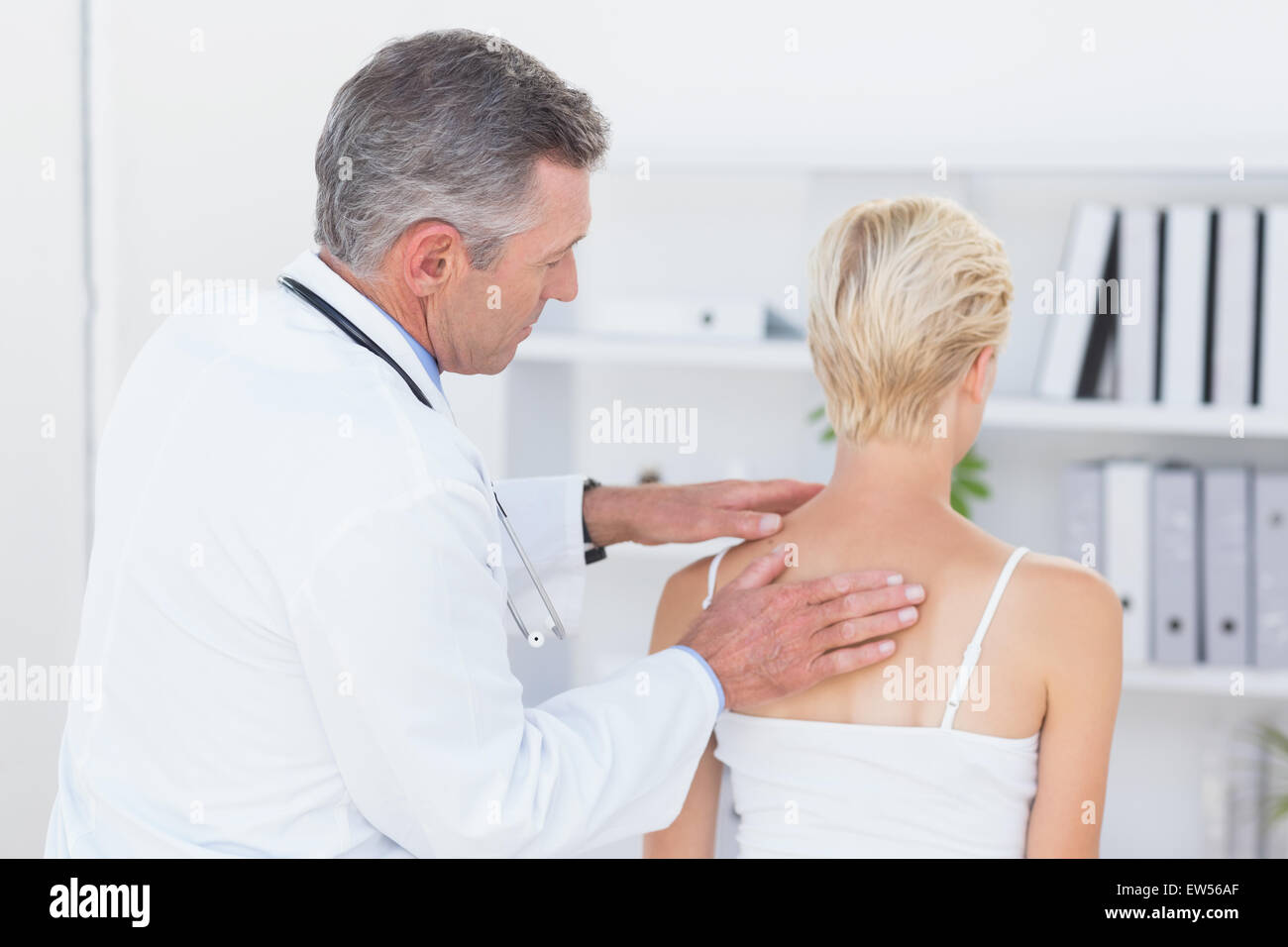 Doctor examining his patient back Stock Photo - Alamy