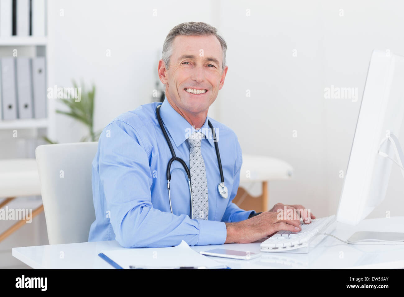 Concentrating doctor using computer Stock Photo - Alamy