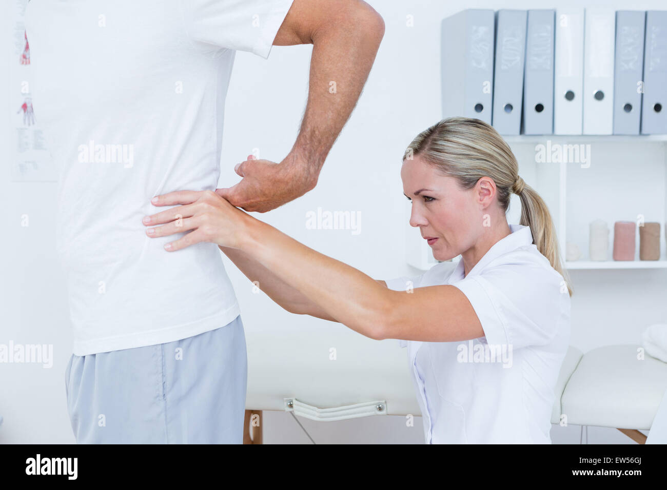 Doctor examining her patient back Stock Photo - Alamy