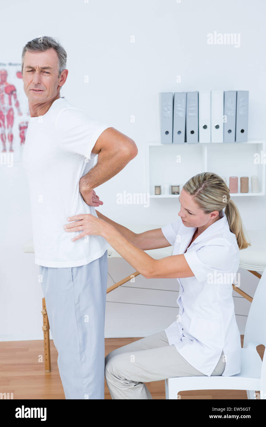 Doctor examining her patient back Stock Photo - Alamy