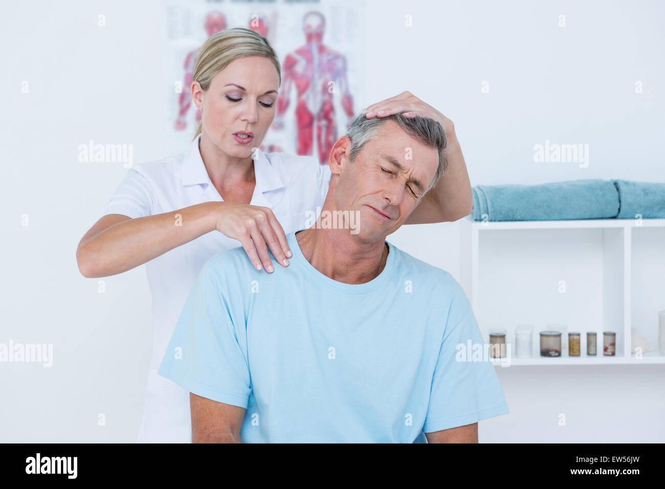 Doctor examining her patient neck Stock Photo - Alamy
