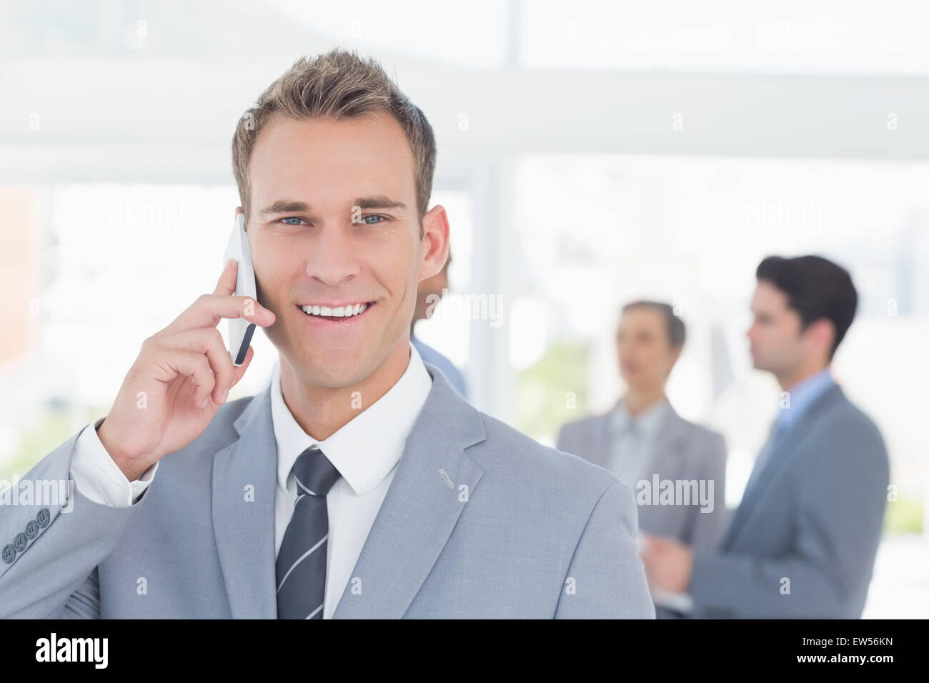 Businessman having phone call while his colleagues discussing Stock ...
