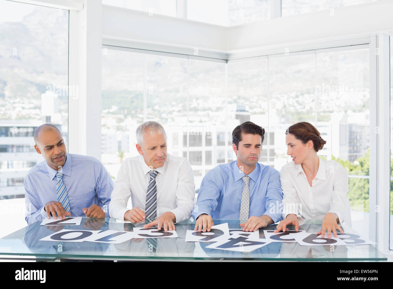 Concentrated business team sitting with their vote on the desk Stock ...