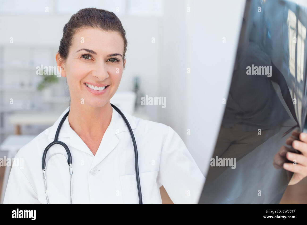 Smiling doctor looking at camera with Xray Stock Photo - Alamy