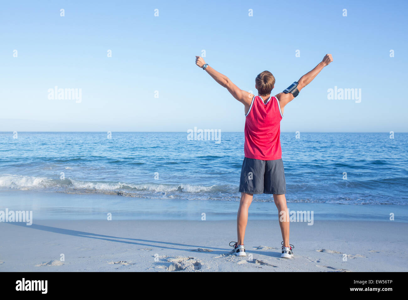 Handsome man raising arms Stock Photo - Alamy