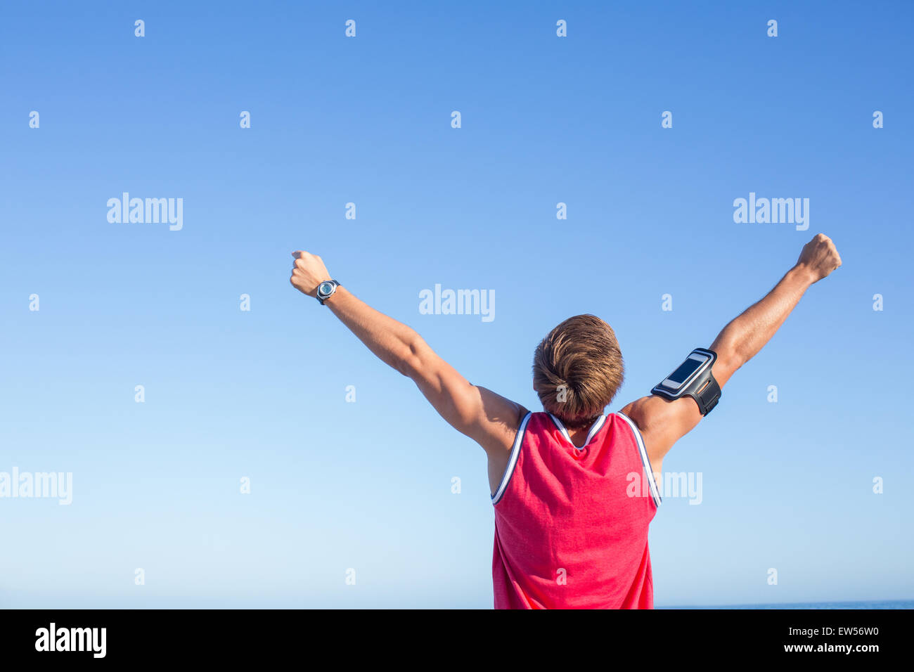 Handsome man raising arms Stock Photo - Alamy