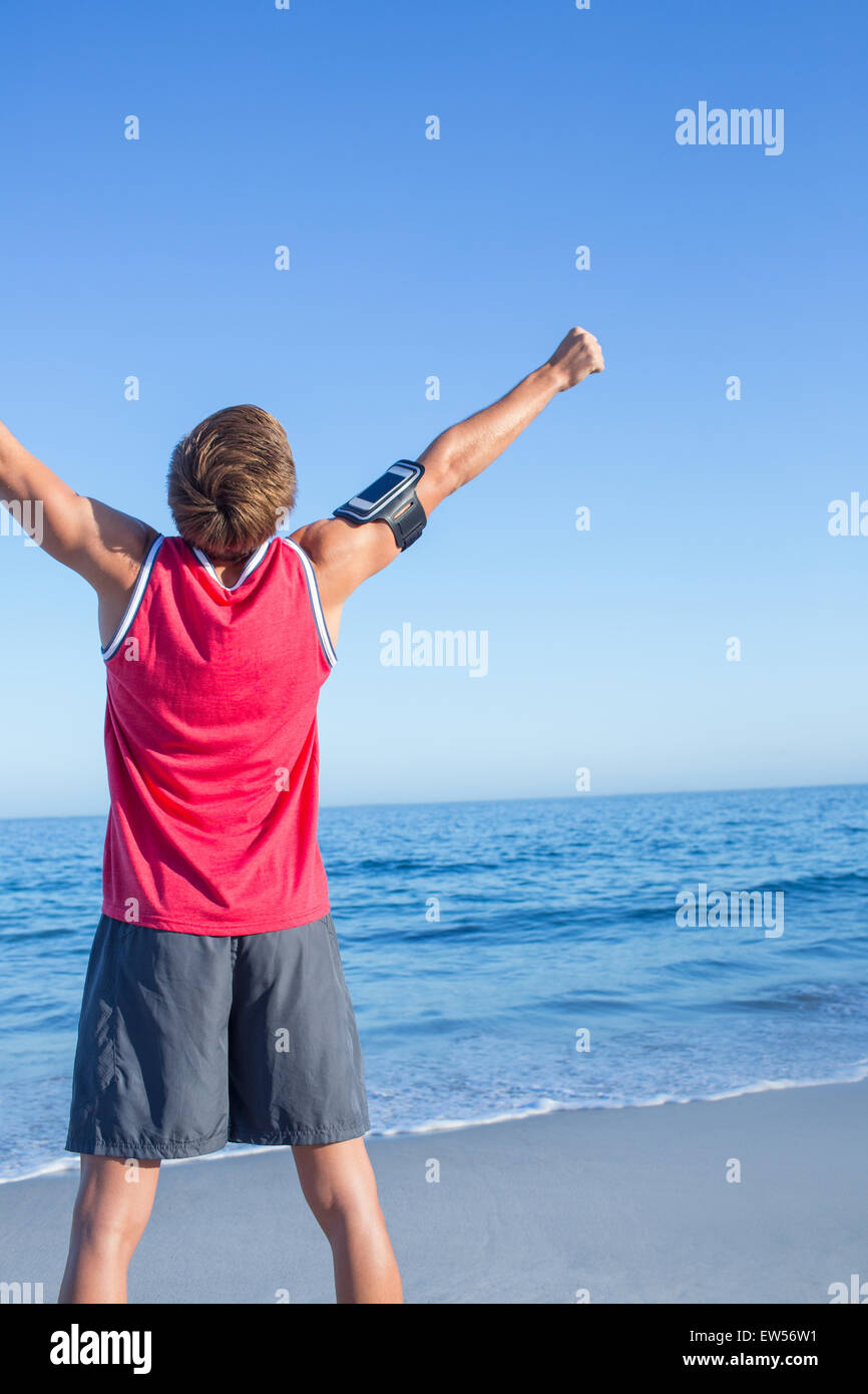 Handsome man raising arms Stock Photo - Alamy