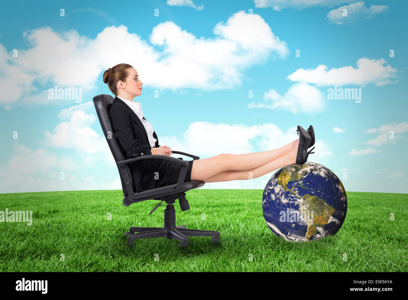 Composite image of businesswoman sitting on swivel chair with feet up ...