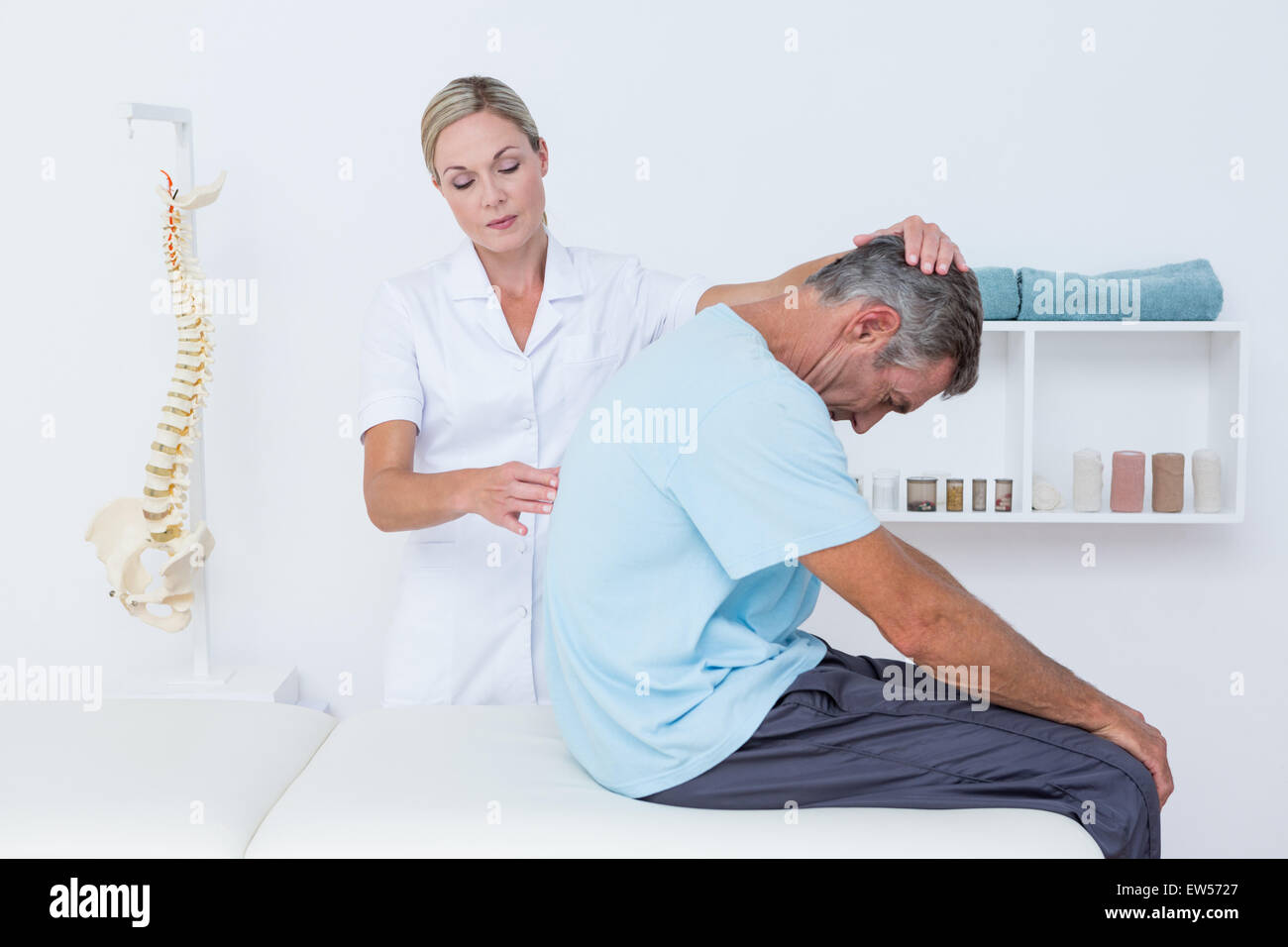 Doctor stretching a man back Stock Photo - Alamy