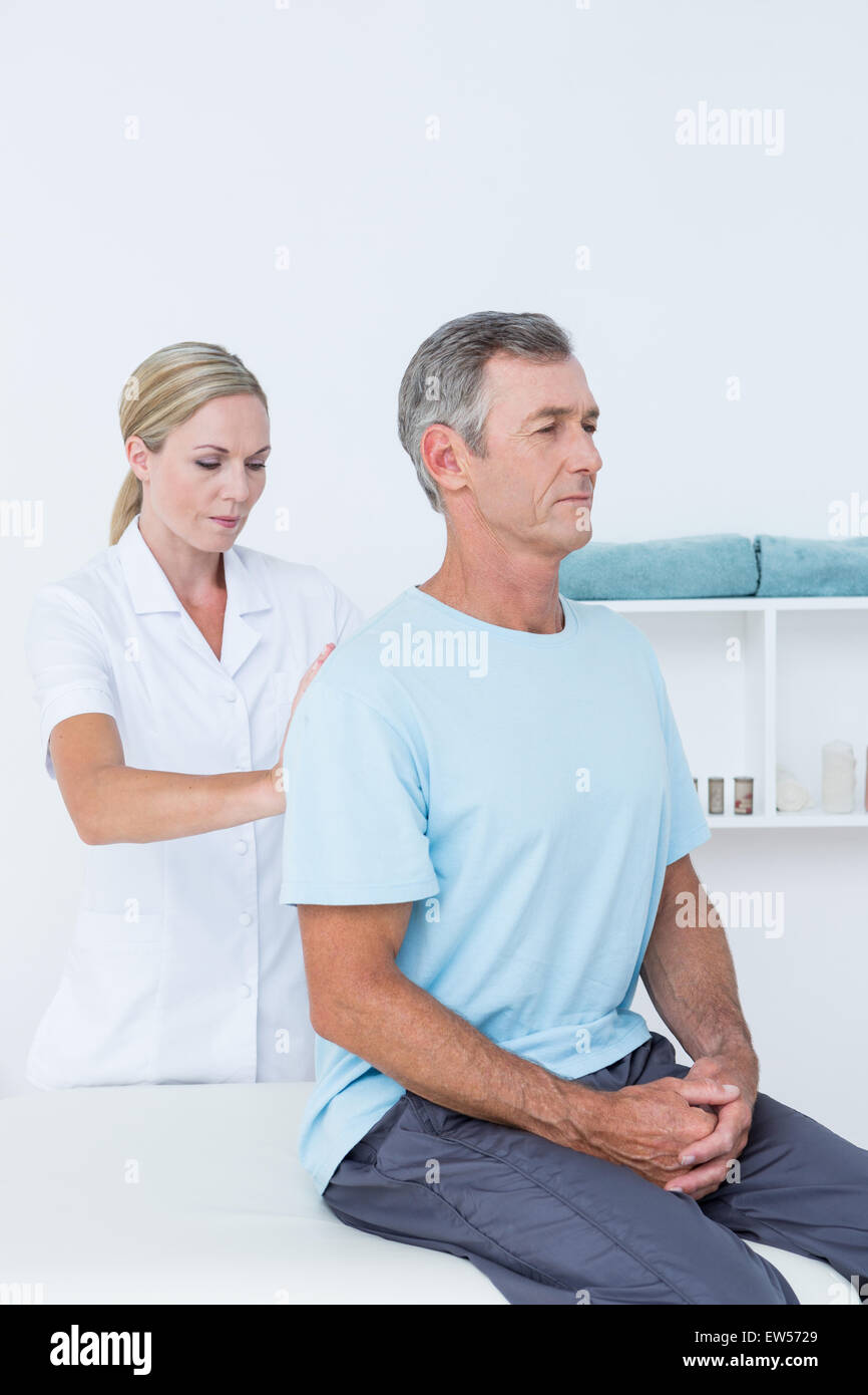 Doctor examining her patient back Stock Photo - Alamy