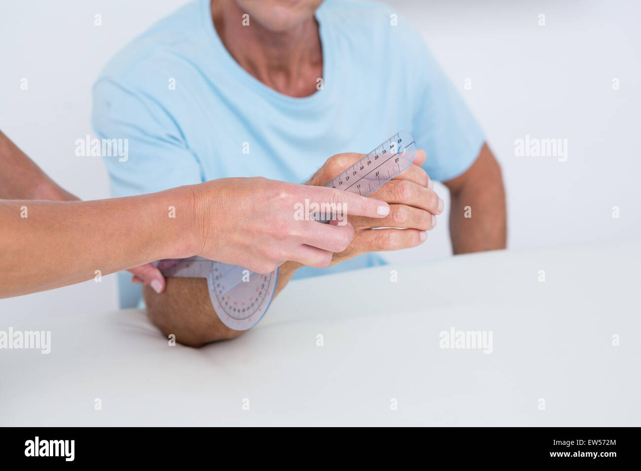 Doctor measuring arm with goniometer Stock Photo - Alamy