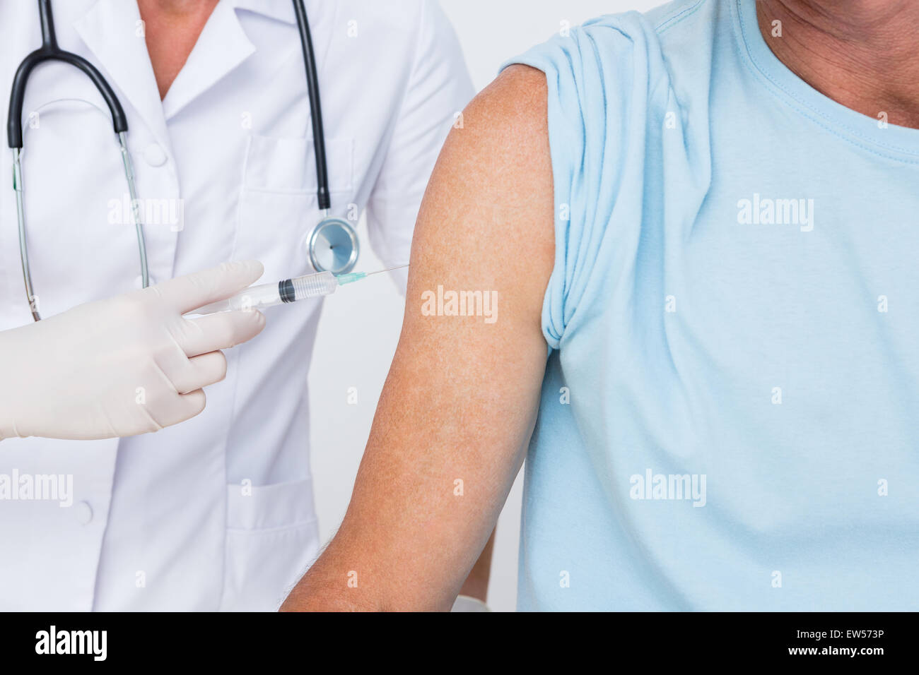 Doctor doing an injection to her patient Stock Photo - Alamy