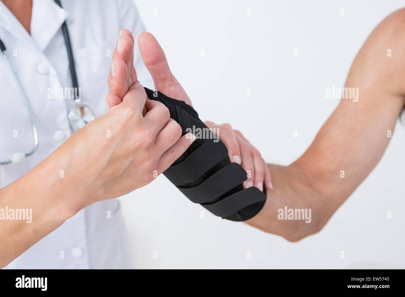 Doctor examining a man wrist Stock Photo - Alamy