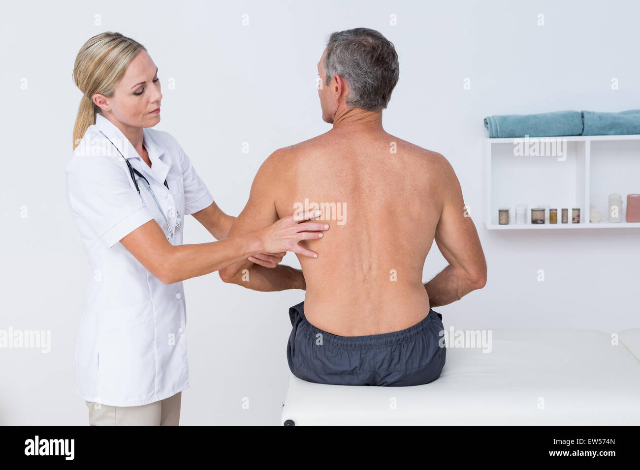 Doctor examining her patient arm Stock Photo - Alamy