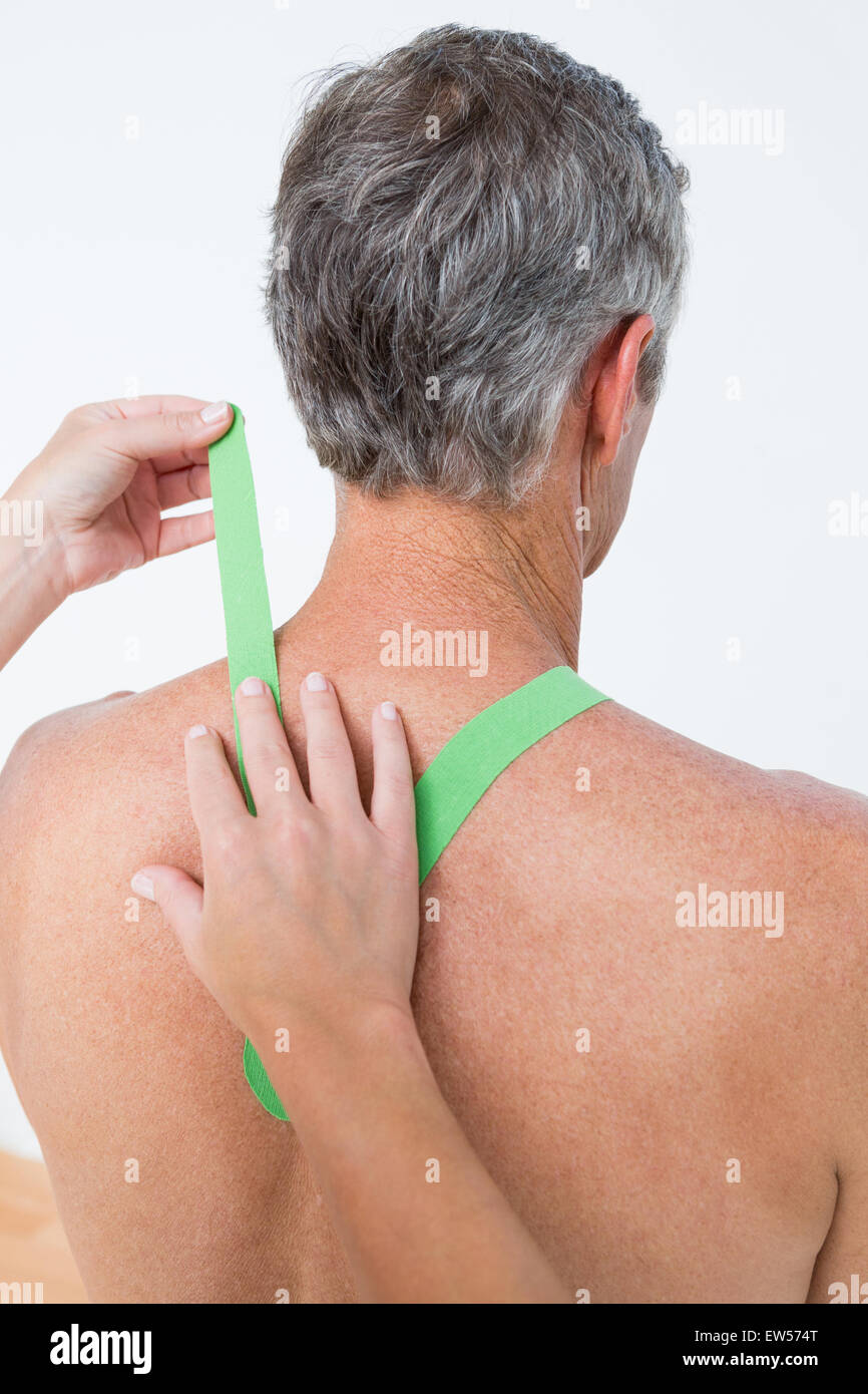 Doctor examining her patient shoulder Stock Photo - Alamy