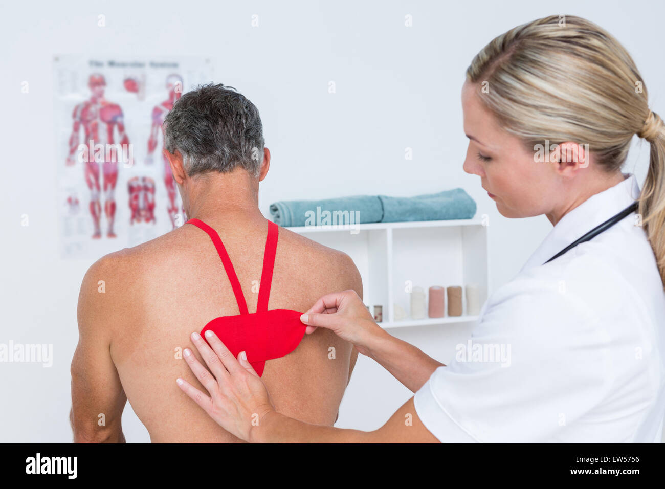 Doctor examining her patient back Stock Photo - Alamy