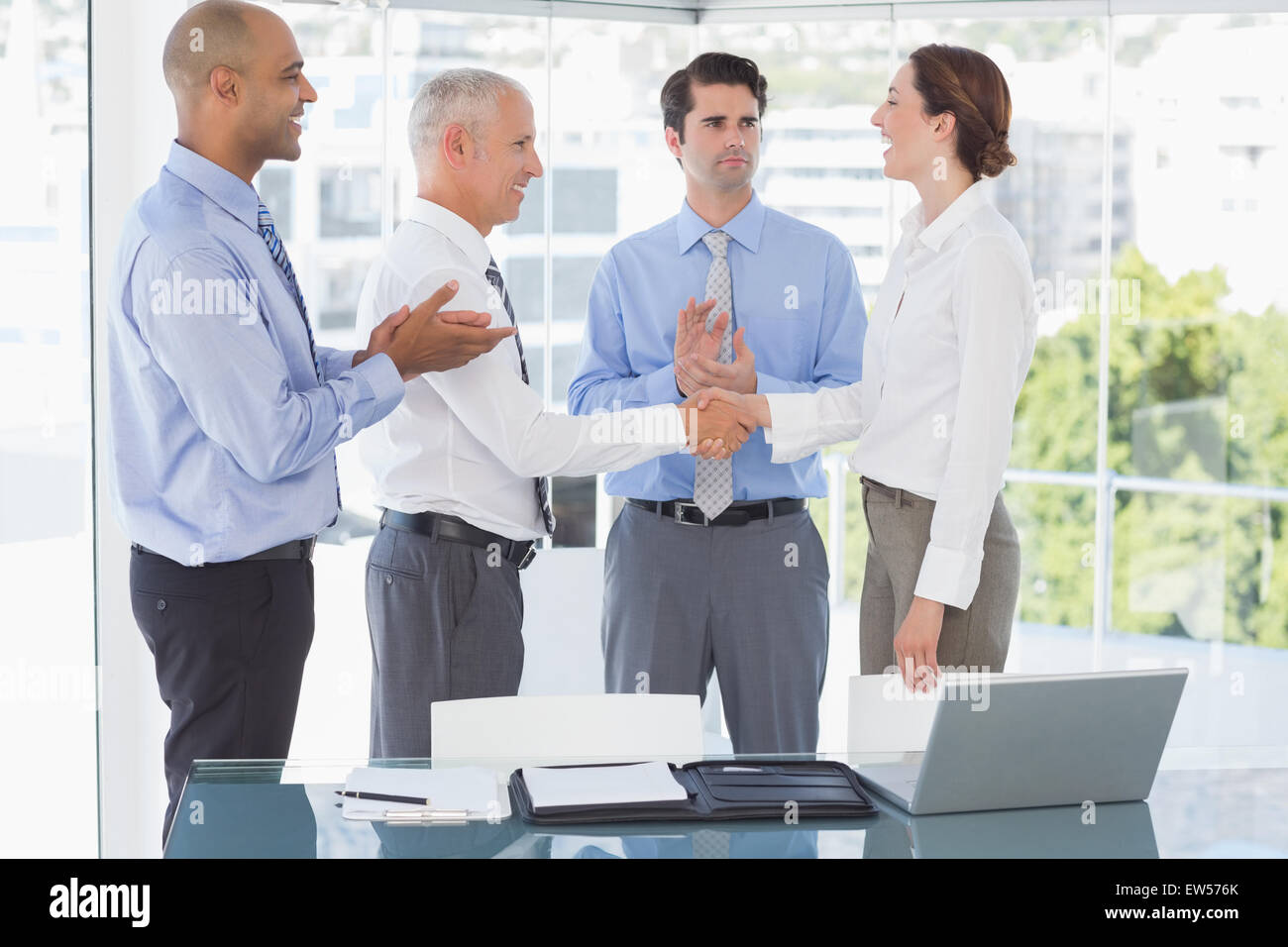 Business team congratulating their colleague Stock Photo - Alamy