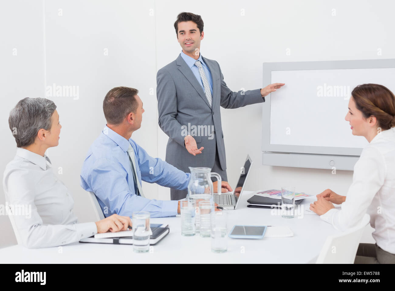 Businessman pointing the white screen Stock Photo - Alamy