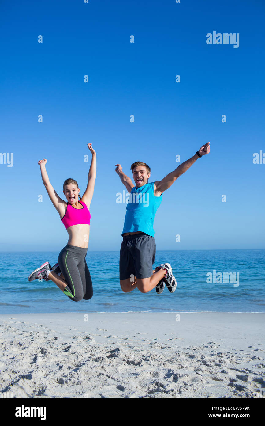 Happy couple jumping together Stock Photo - Alamy