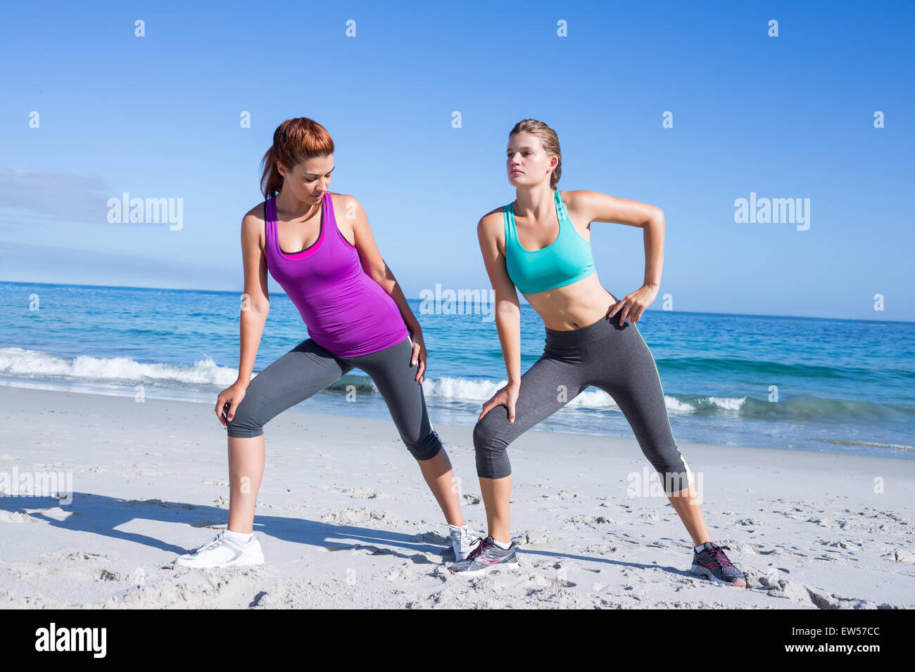 Friends stretching together beside the water Stock Photo - Alamy