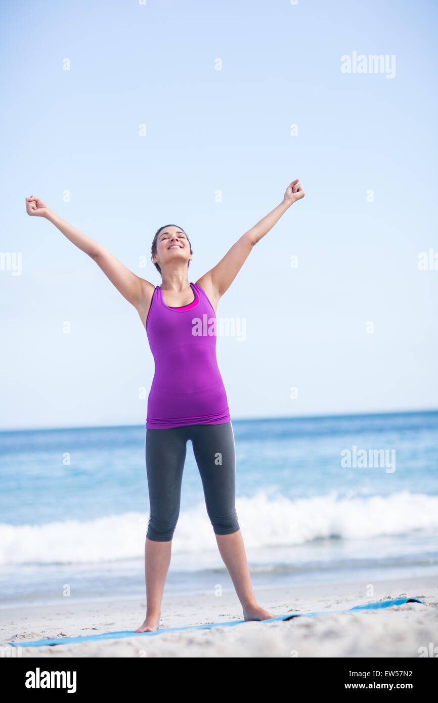 Pretty brunette raising arms Stock Photo - Alamy