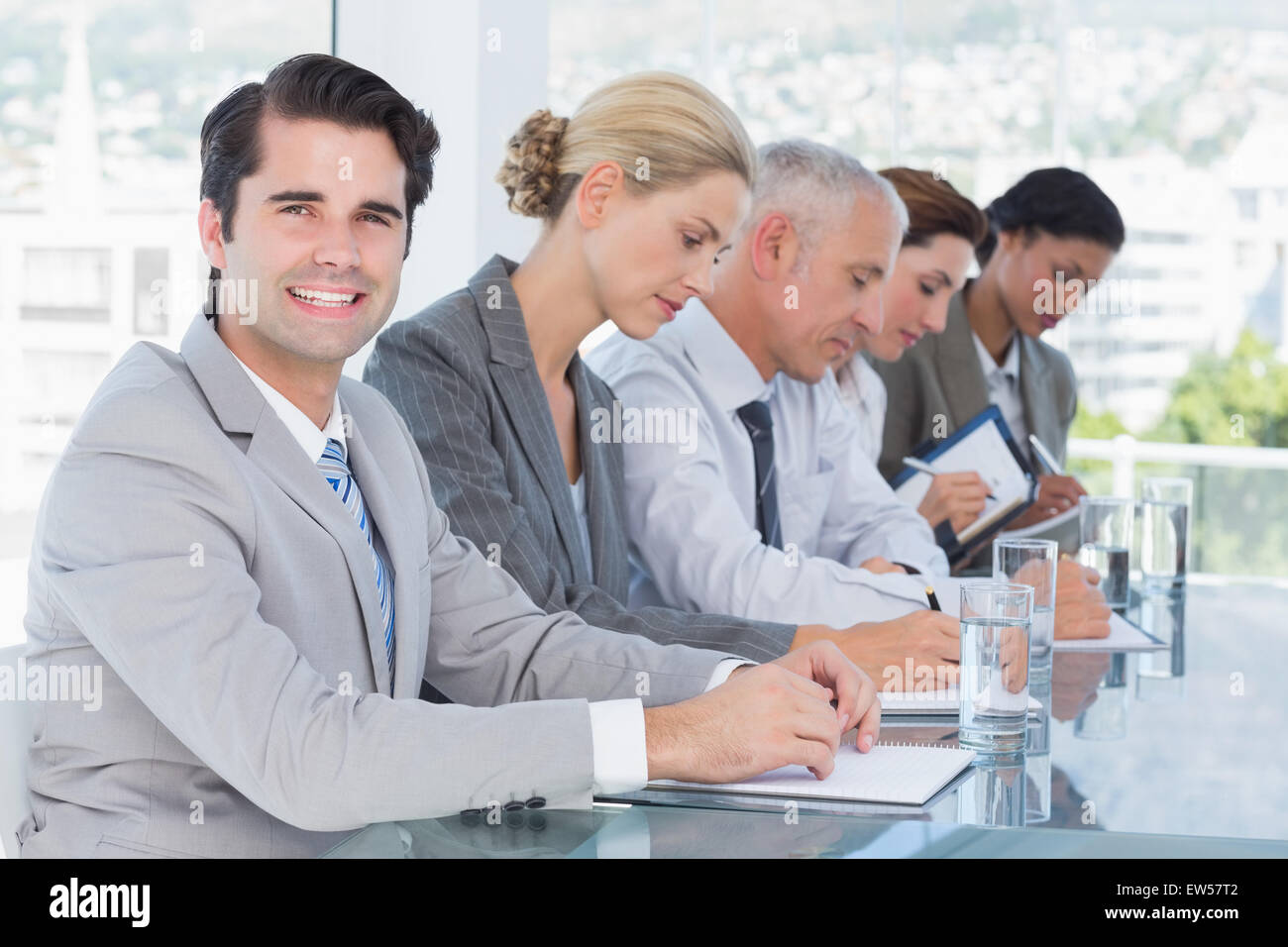 Business team taking notes during conference Stock Photo - Alamy